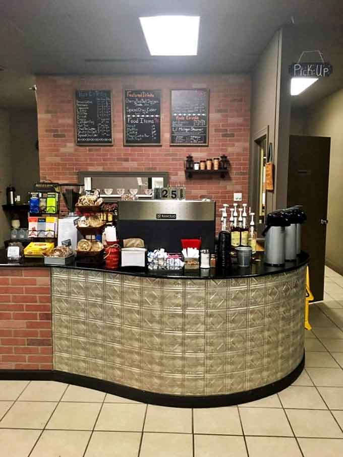 The efficient counter setup with brick accents and chalkboard menus keeps things simple while the kitchen focuses on excellence.