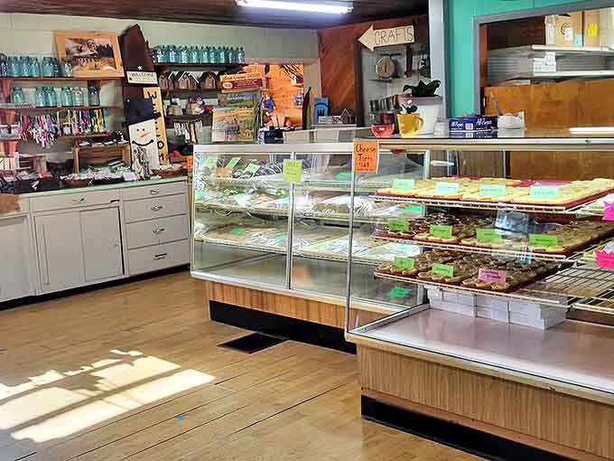 Sunlight streams through windows onto wooden floors and simple furnishings, highlighting the bakery's commitment to unpretentious excellence.