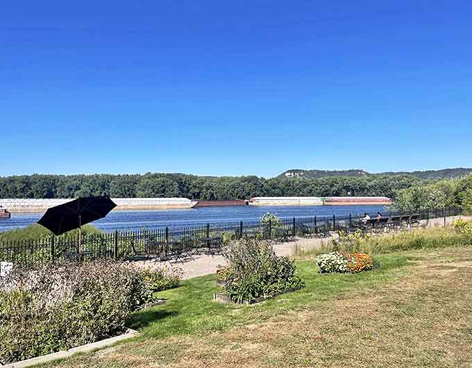 The view: Barges glide along the mighty Mississippi beyond the museum gardens, creating a living connection between the artwork inside and the working river outside.