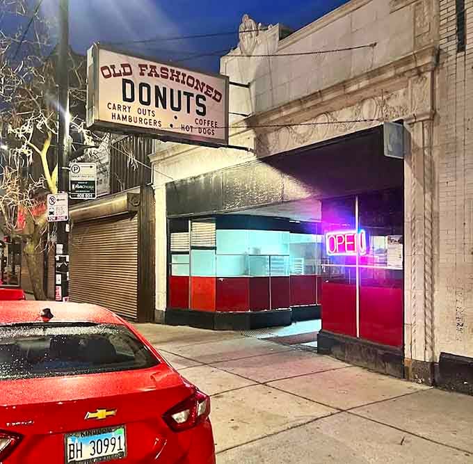 Nighttime exterior glowing with promise: the donut beacon that calls to night owls and early birds with equal magnetic pull.
