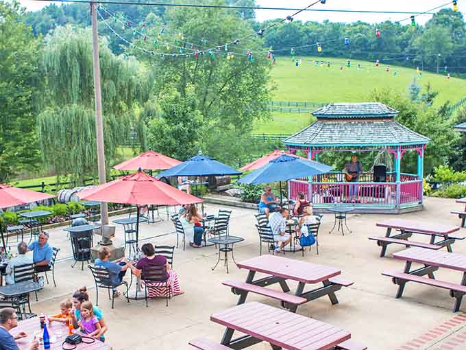 Live music drifts across this perfect summer scene, where umbrellas provide shade and wine provides the perfect afternoon soundtrack.