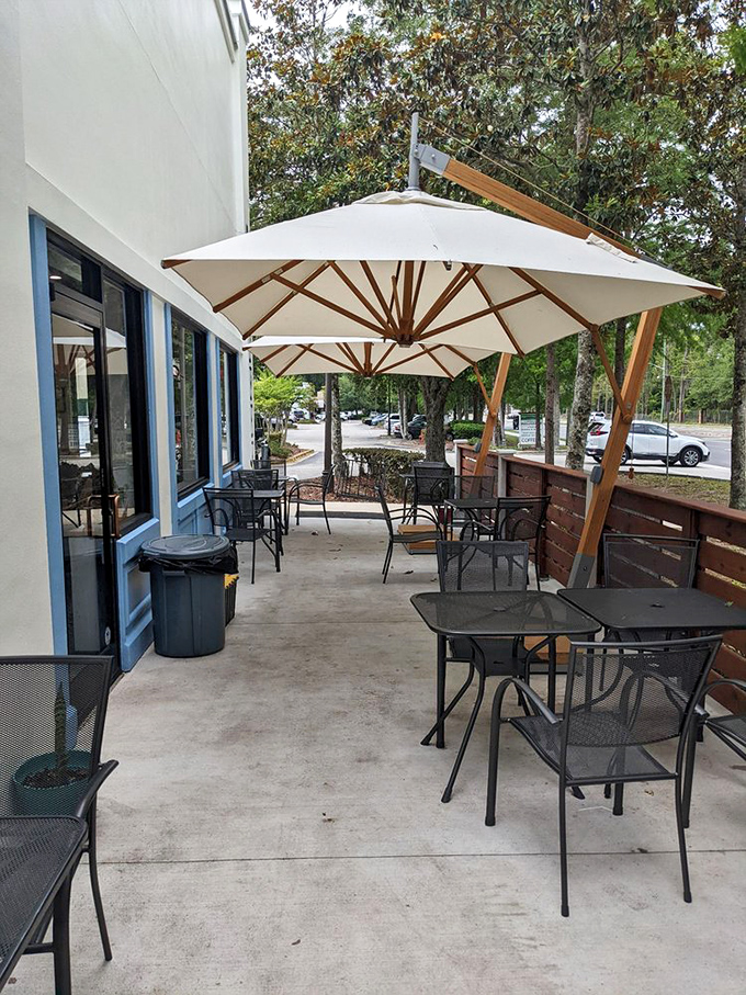 Outdoor seating under generous umbrellas &ndash; because sometimes doughnuts taste even better with a side of fresh air and people-watching.