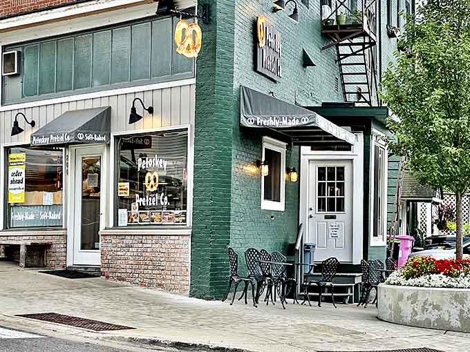 The green exterior and outdoor seating create an inviting oasis on Petoskey's charming streets, perfect for people-watching while pretzel-munching.