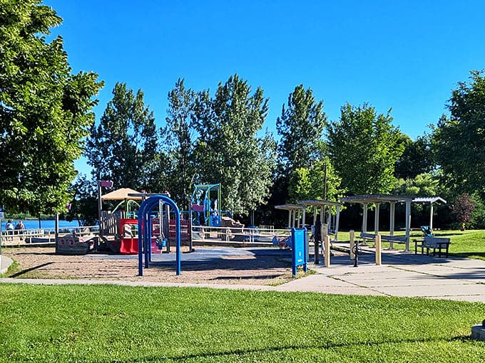 Primary colors pop against green grass at this playground oasis, where childhood laughter provides the park's happiest soundtrack.