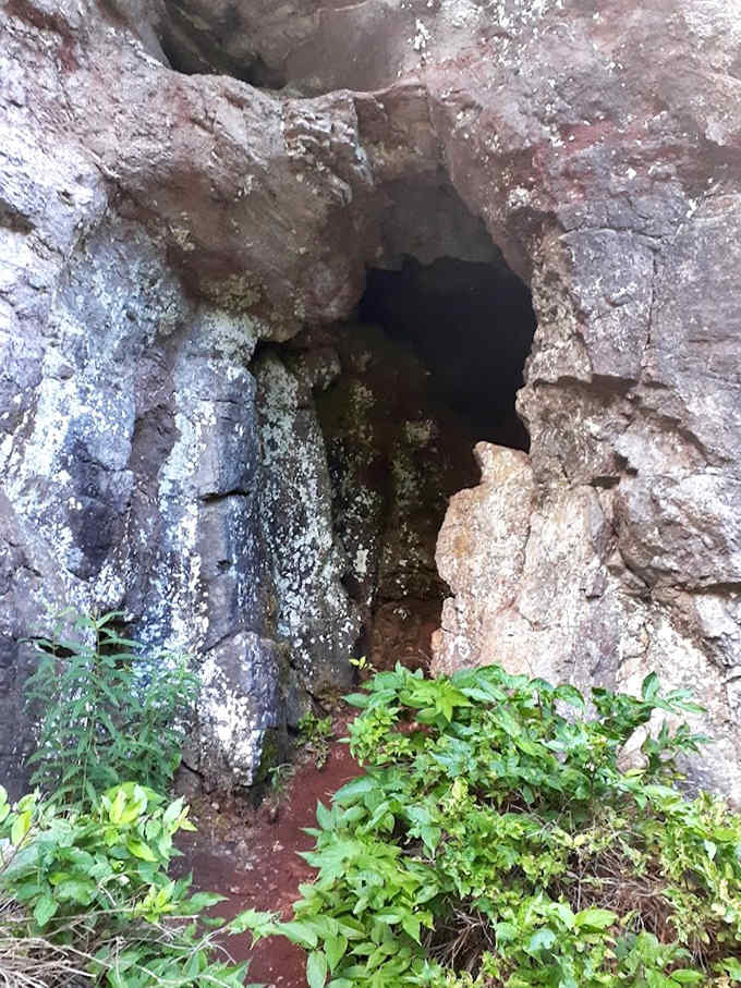 Nature creates its own architecture &ndash; this rock alcove looks like a doorway to another world, moss-lined and mysterious.