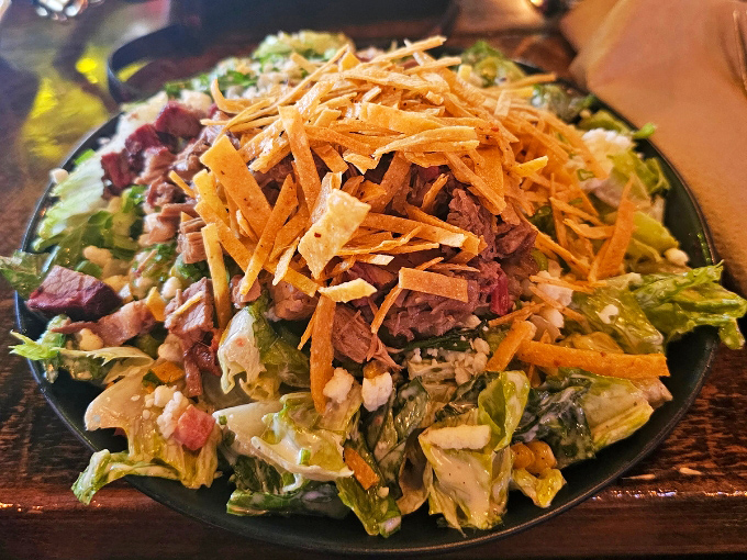 The Texas Garden Salad brings together crisp vegetables, smoked meat, and crunchy tortilla strips in a refreshing counterpoint to rich barbecue.