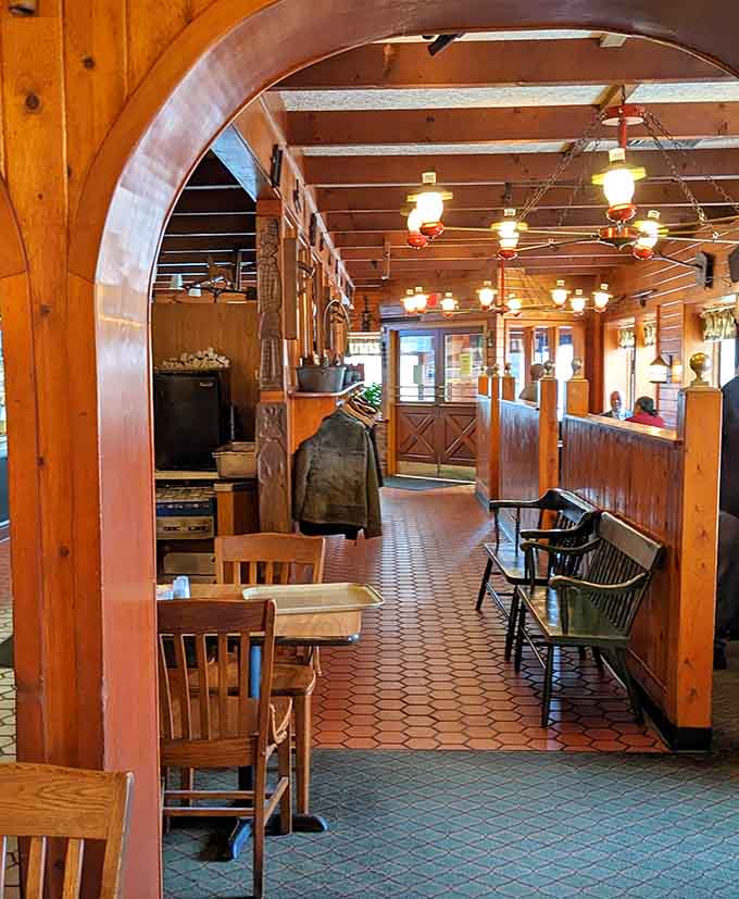Multiple dining areas connected by those charming archways mean there's always a cozy spot to settle in and enjoy your generously portioned comfort food feast.