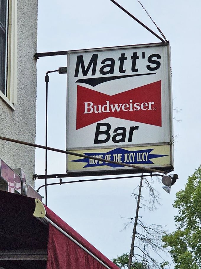 The vertical neon sign stands tall against the Ohio sky, a landmark for sweet-toothed travelers seeking sugary salvation.