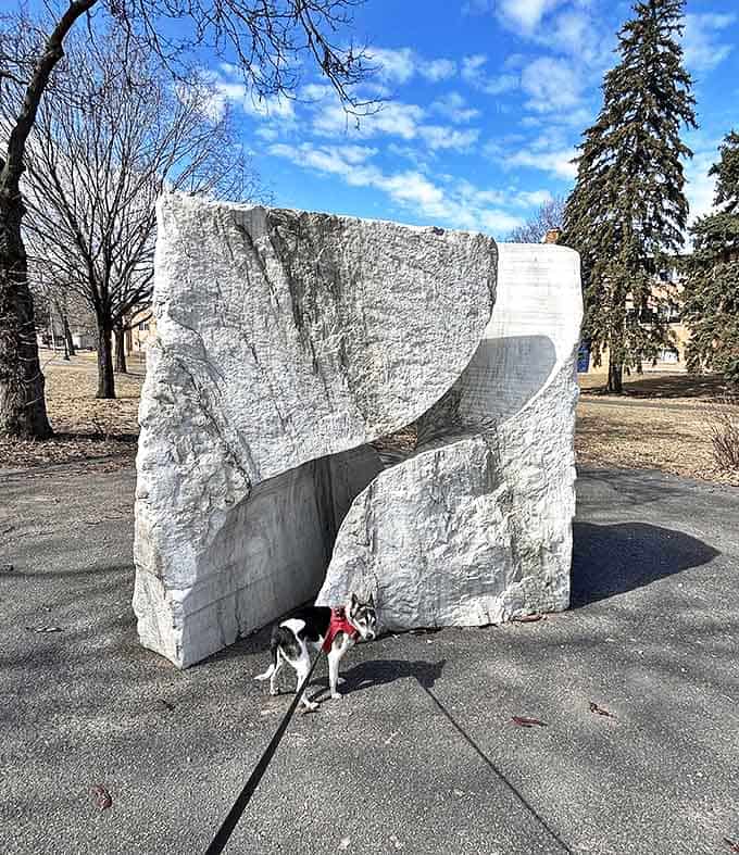 This massive white stone sculpture with its smooth curves and sharp angles offers a meditation on contrast against the park's natural setting.