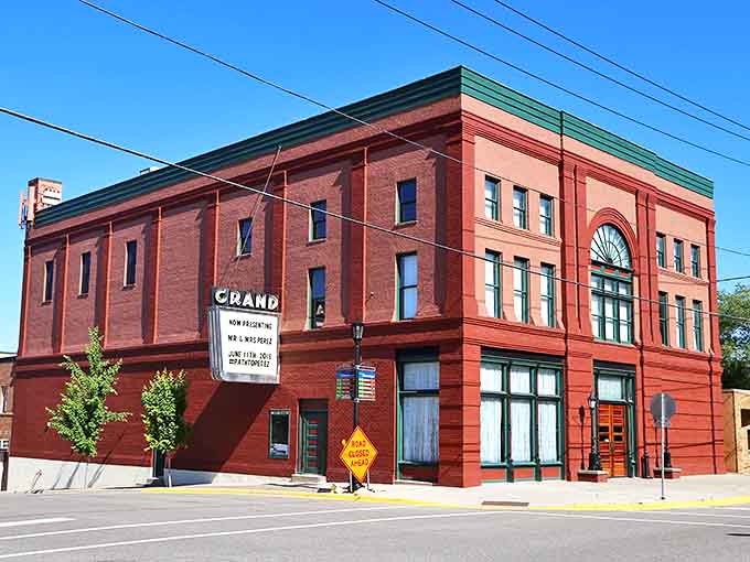 The Grand Event Center's bold red exterior houses celebrations and performances in a beautifully restored 1899 building with original architectural details.