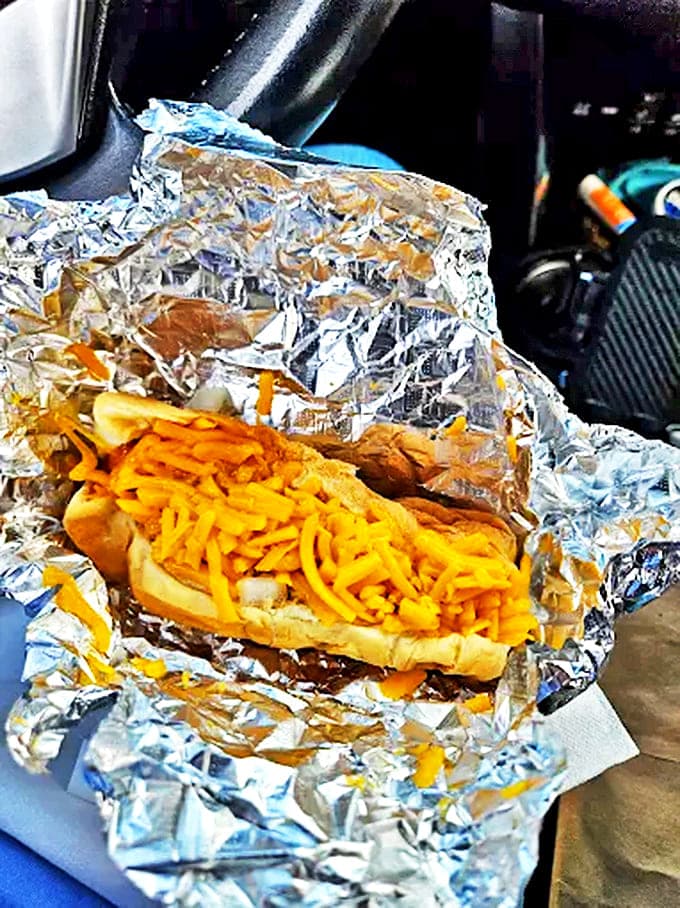 The chili cheese dog wrapped like a gift, which it essentially is &ndash; a present of melted cheese, savory chili, and pure happiness.