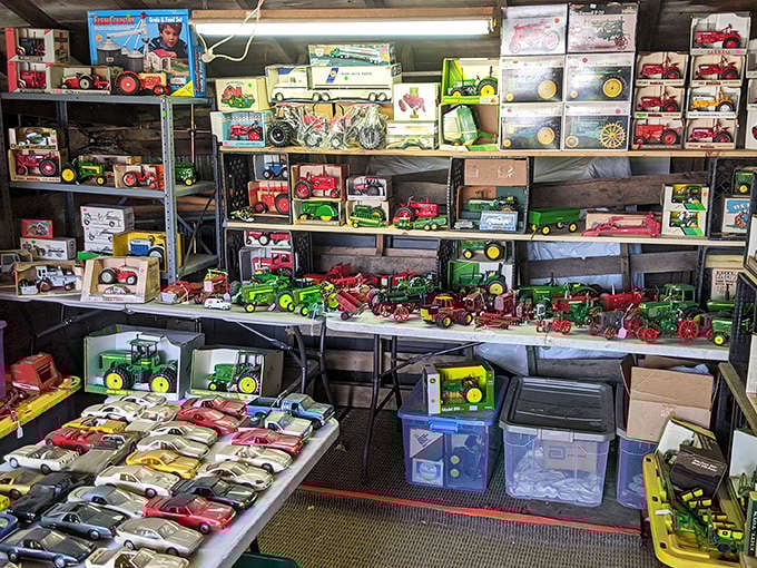Vintage toys in remarkable condition line metal shelves &ndash; model tractors, cars, and trains representing America's love affair with transportation.