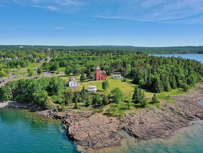 From above, the lighthouse grounds reveal their strategic position between two harbors, explaining why this spot was chosen for this vital beacon.