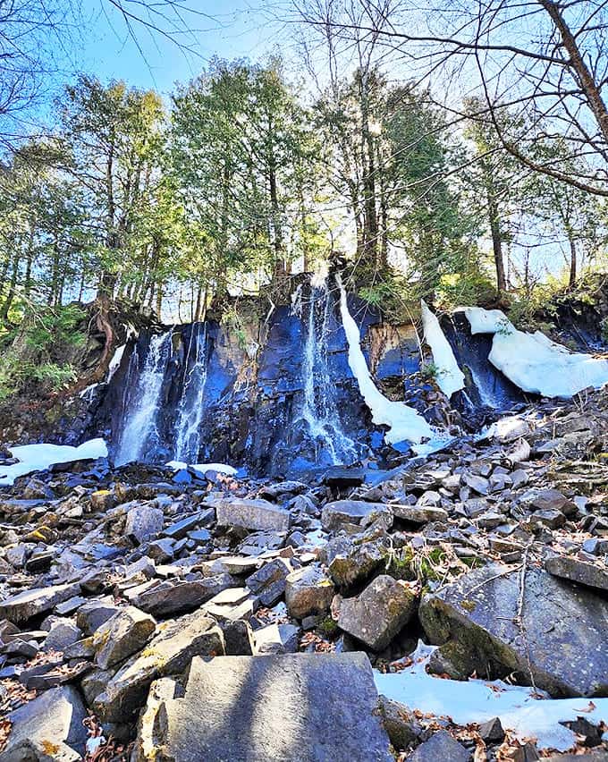 The upper section of Bridal Falls spreads across this impressive rock ledge, demonstrating water's patient power to shape even the hardest stone.