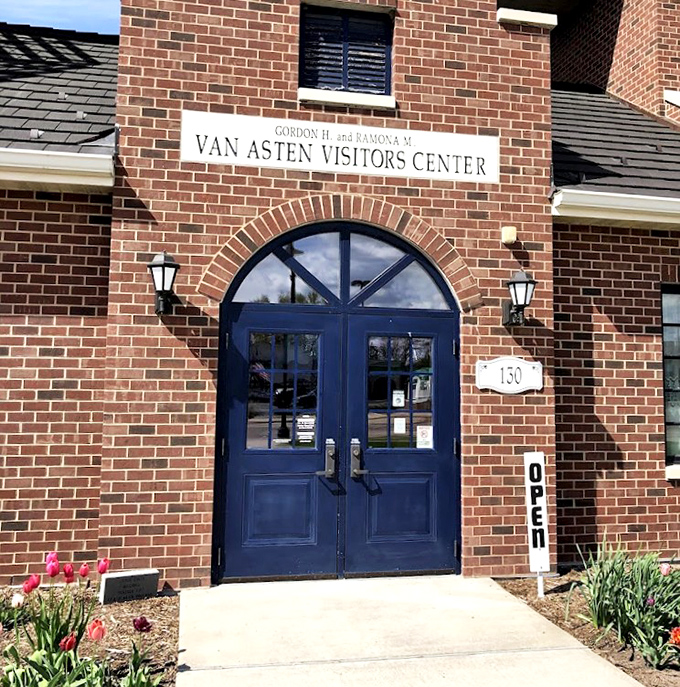 The windmill's impressive wooden blades stretch toward the sky, a testament to traditional Dutch engineering that still functions perfectly today.