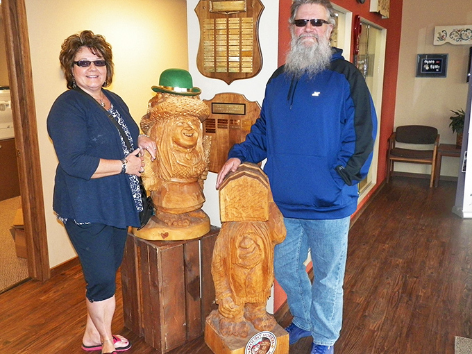 Visitors pose with carved wooden figures at the center, proving trolls make excellent photo companions regardless of your age or Instagram following.