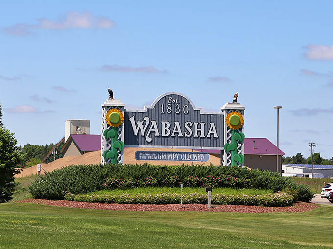 Sunlight catches Wabasha's town sign where playful eagles perch above sunflowers, announcing you've arrived somewhere special along the Mississippi's storied banks.