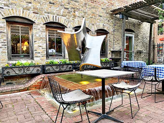 The patio's sculptural fountain creates a peaceful soundtrack for outdoor dining&mdash;an artistic centerpiece that transforms a simple meal into an occasion.