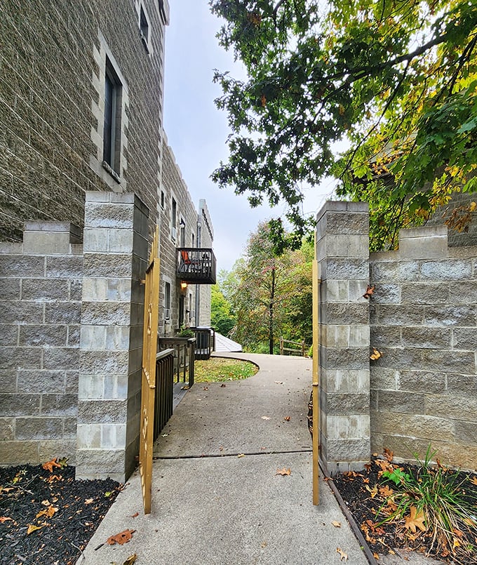 Stone pillars frame the pathway into the castle grounds, creating a sense of transition from the ordinary world to somewhere extraordinary.