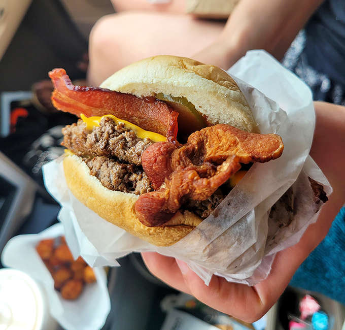 Bacon makes everything better, especially when layered atop a perfectly grilled burger with melty cheese.