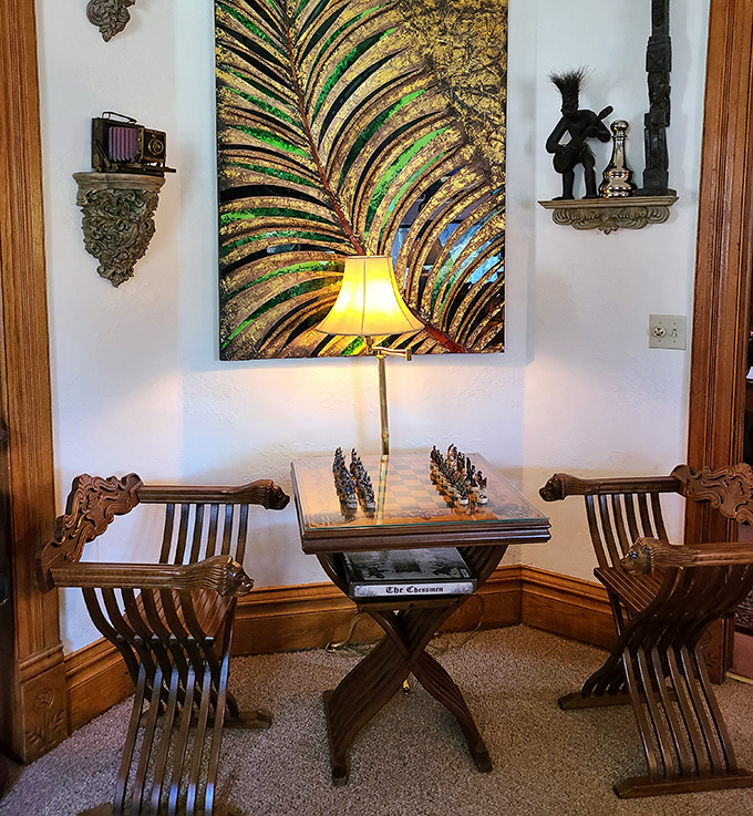 Even chess becomes an adventure when played on antique furniture beneath artwork that seems to shimmer with mechanical possibility.