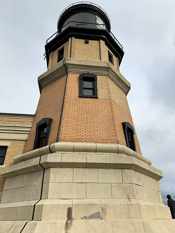 The lighthouse tower's detailed brickwork showcases the craftsmanship of another era. Its octagonal design has withstood over a century of Lake Superior's fiercest storms.