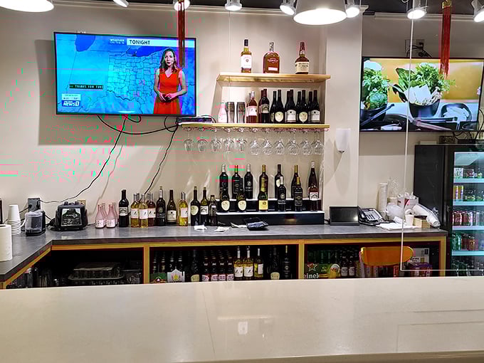 The bar area offers a moment of respite between hotpot rounds, where friendly staff prepare drinks while robots whir by with their precious cargo.