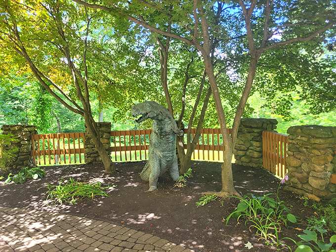 The resident dinosaur stands guard among the trees, because every castle needs unexpected surprises to keep visitors on their toes.