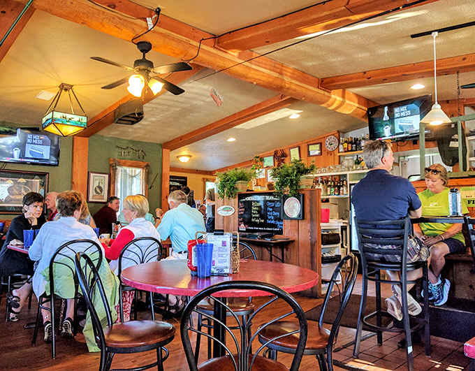 The bar area buzzes with conversation as regulars and newcomers alike gather to share stories over cold drinks and hot plates.