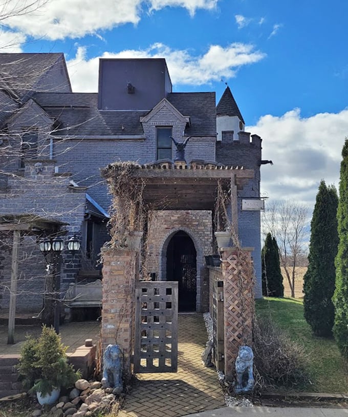 The castle entrance welcomes visitors through an arched gateway flanked by stone lions, the first hint of the wonders waiting beyond.