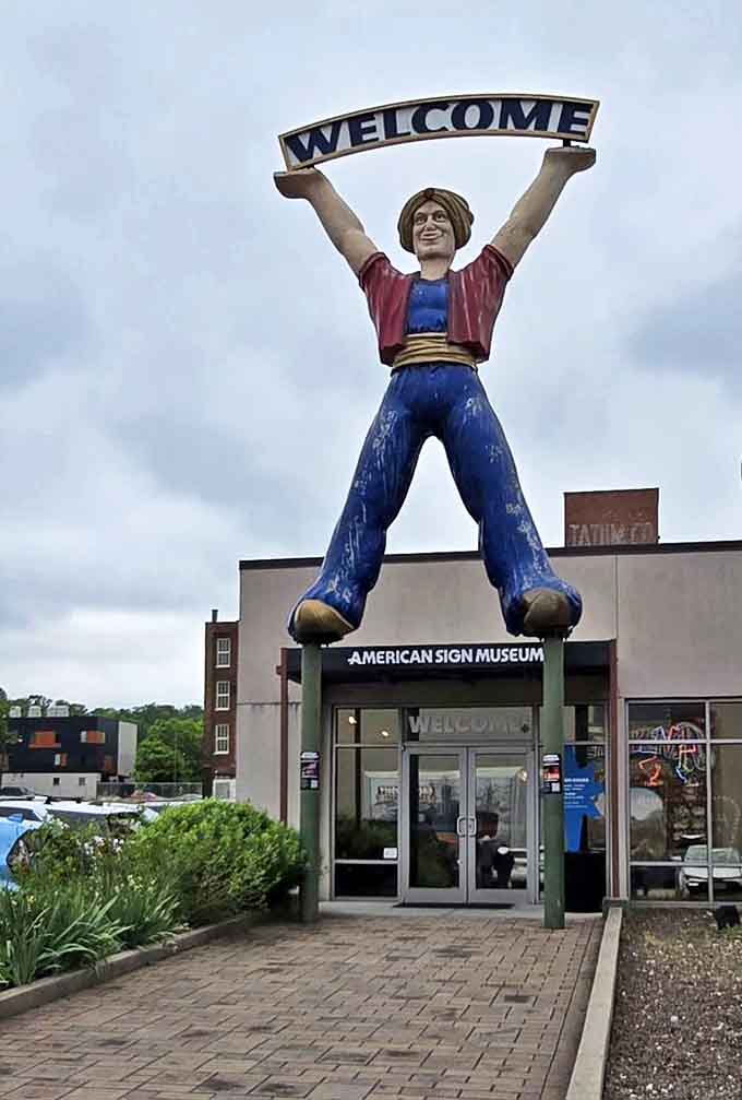 This giant "Welcome" figure stretches his arms wide, a fiberglass ambassador from a friendlier commercial era inviting you inside.