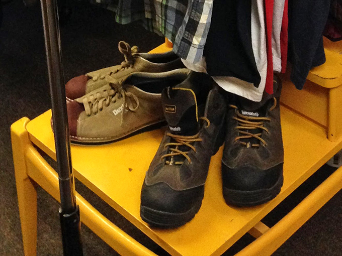 Vintage footwear awaits new adventures on sunny yellow shelves &ndash; each pair having already walked through one era and ready for another.