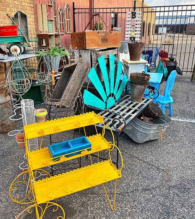 Bright turquoise chairs pop against rusty metal planters and vintage garden implements, offering colorful possibilities for outdoor spaces with character.