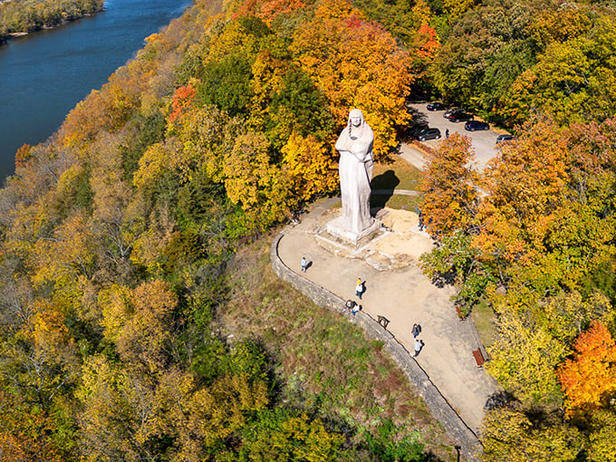 An aerial perspective reveals how perfectly the statue is positioned on its bluff, overlooking the winding Rock River like a patient guardian.