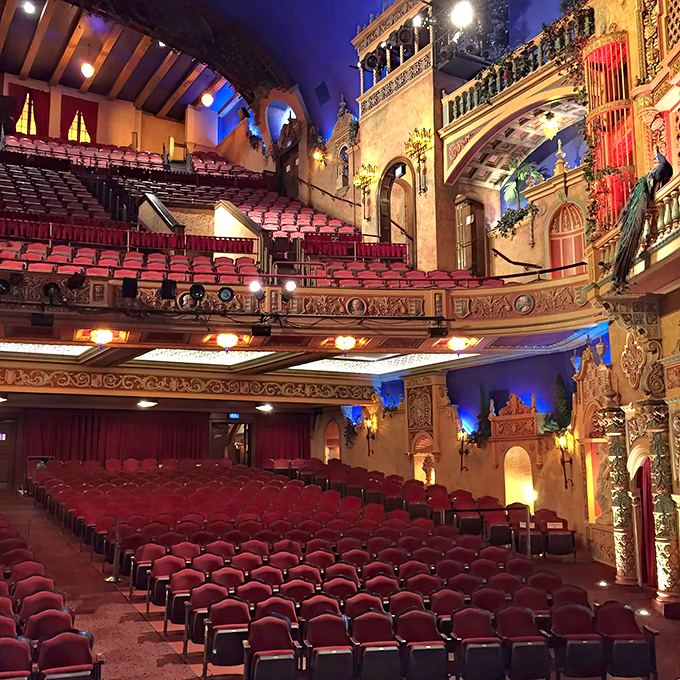 Red velvet seats cascade toward the stage while Mediterranean fantasy balconies hover above&mdash;proof that the best theaters don't just host shows, they are the show.