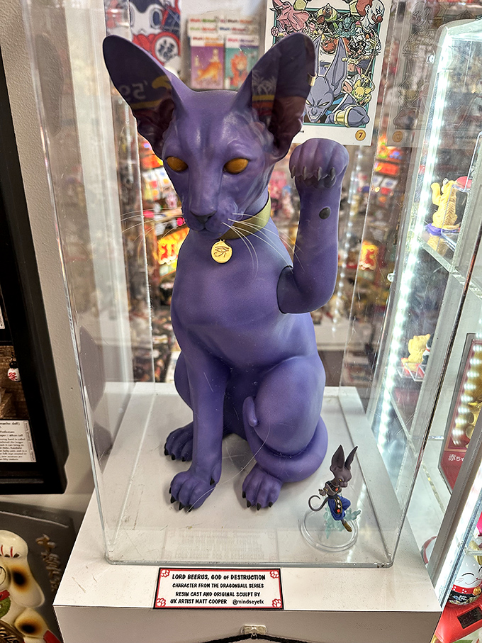Lord Beerus from Dragon Ball Super stands regally in his display case, representing modern anime's continued fascination with powerful feline figures.