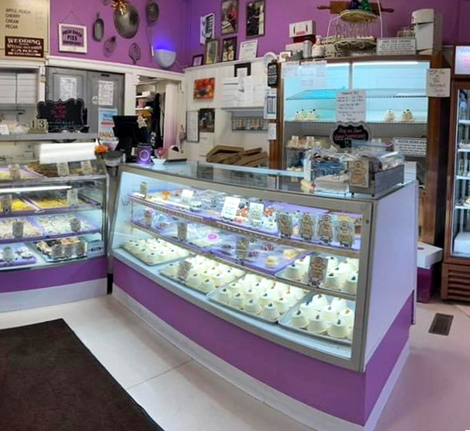 The purple-trimmed display cases showcase daily treasures like a museum of edible art, each shelf a different gallery of temptation.