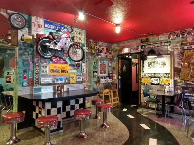 Chrome stools, checkered floors, and walls covered in Americana create the perfect setting for an authentic diner experience.