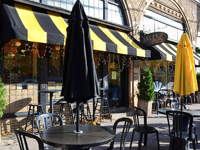 Outdoor seating under yellow umbrellas, perfect for pretending you're in a European caf&eacute; while eating Midwestern pastries.