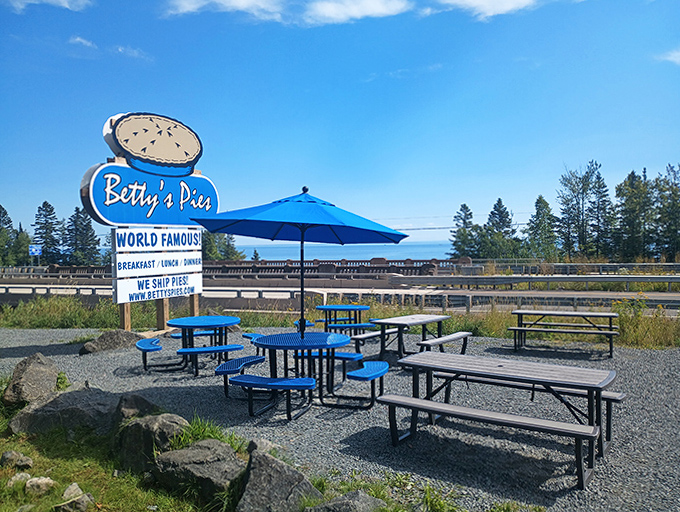 Outdoor seating with the iconic sign &ndash; perfect for enjoying your slice with a side of fresh Lake Superior air.