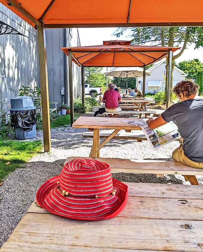The outdoor seating area feels like the backyard gathering you always wish you were invited to, complete with orange umbrellas and casual picnic tables.