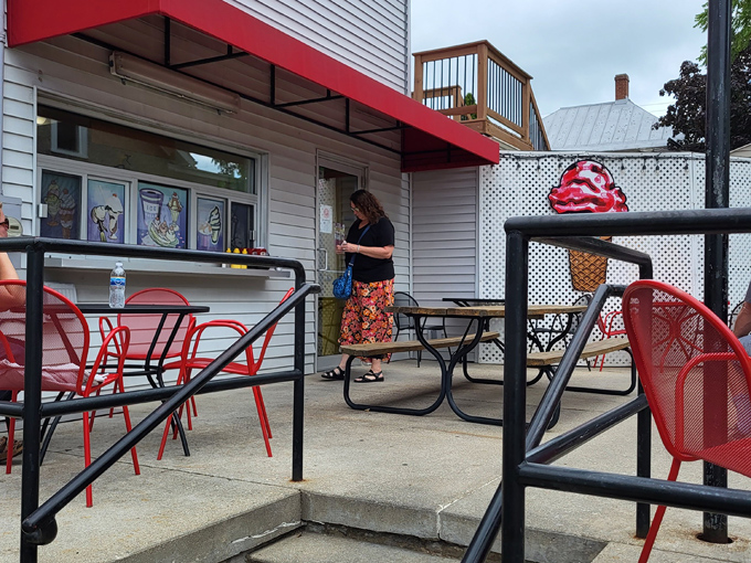 The perfect summer scene &ndash; red chairs, sunshine, and food that makes you forget to check your phone for at least 20 blissful minutes.