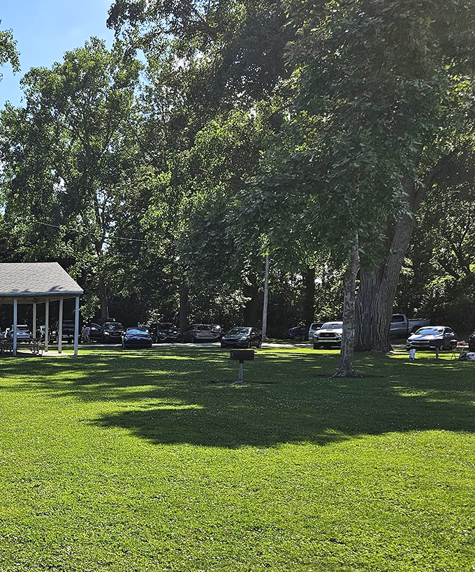 Ample parking nestled among mature trees keeps vehicles cool while their owners soak up the lakeside atmosphere.