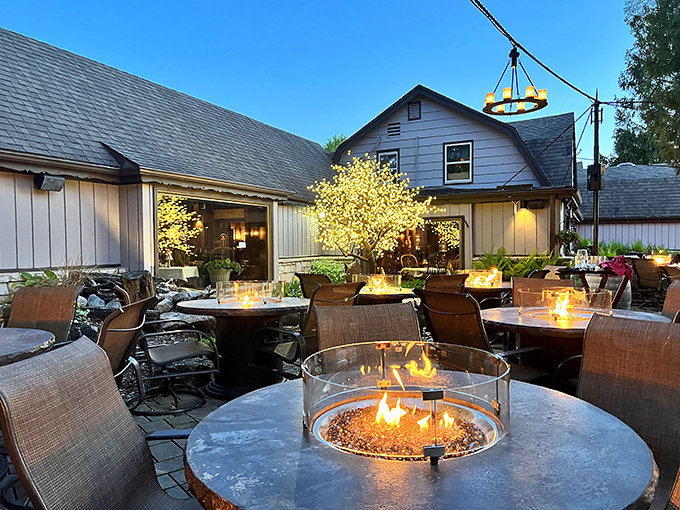 As evening falls, fire tables on the patio create pools of warmth and light, inviting diners to linger over after-dinner drinks.