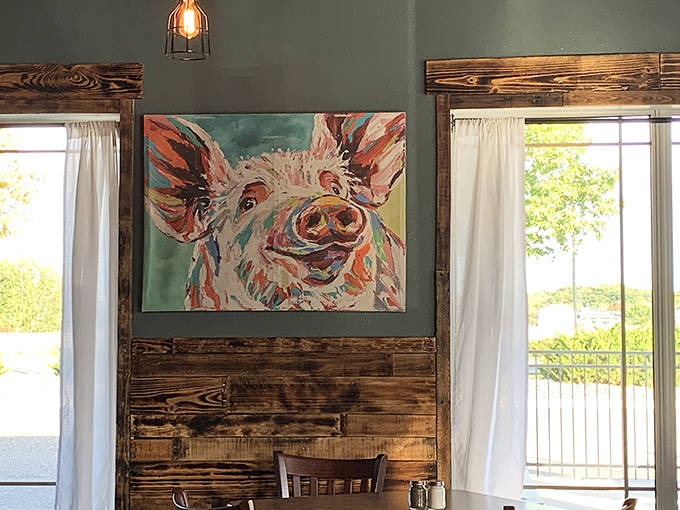 This colorful pig portrait isn't just wall art&mdash;it's practically the restaurant's spirit animal, watching over diners with a knowing smile.