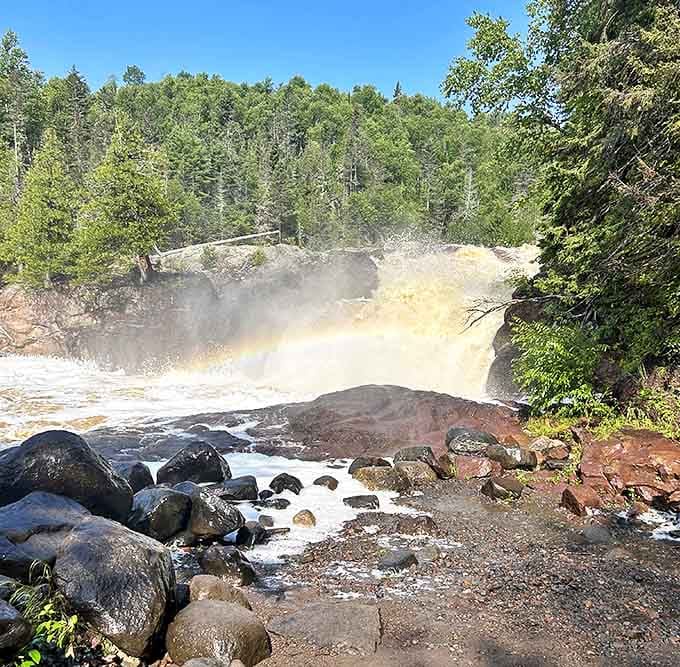 Mother Nature's light show: A perfect rainbow forms in the mist of the thundering falls, adding magical color to the already spectacular scene.