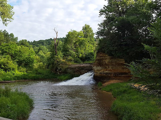 A peaceful bench awaits tired explorers, positioned perfectly for contemplating the falls or simply enjoying a moment of Minnesota tranquility.