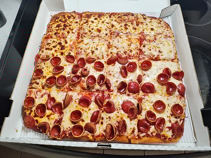 Square-cut pizza creates a democratic dining experience where every piece offers something different &ndash; from cheese-laden centers to perfectly crispy corners.