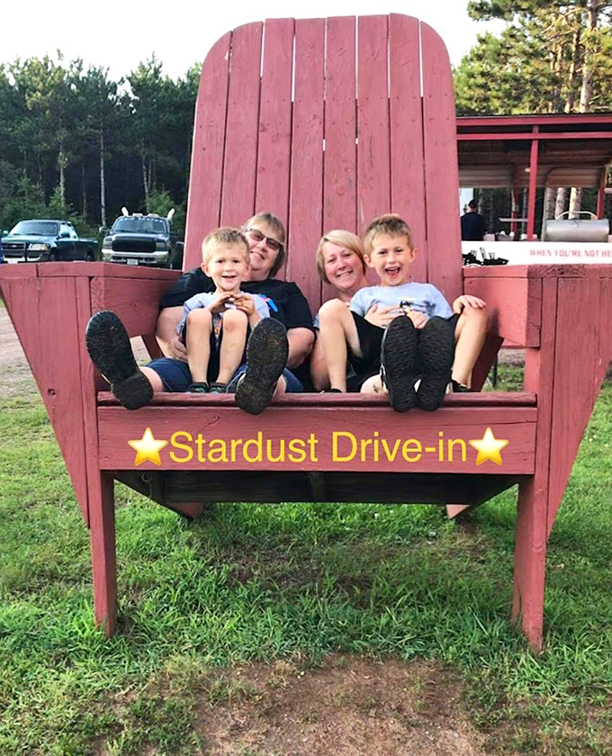 The oversized red Adirondack chair makes for perfect photo opportunities, a favorite spot for family memories.