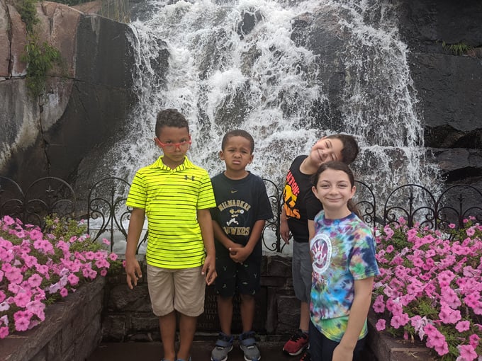 Children gather at the falls, their expressions capturing the wonder that Daggett Memorial Park inspires in visitors of all ages.